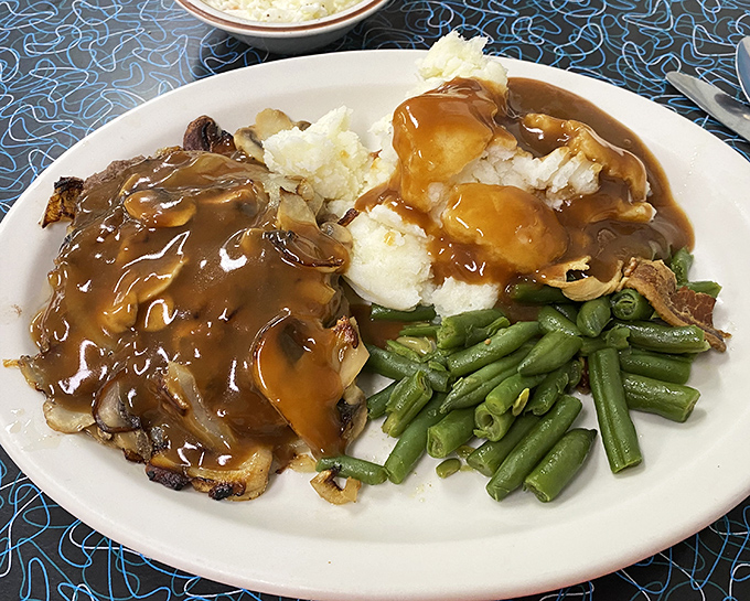 Comfort food doesn't get more comforting than this&mdash;tender chopped sirloin swimming in gravy alongside mashed potatoes and green beans that actually taste like vegetables. 