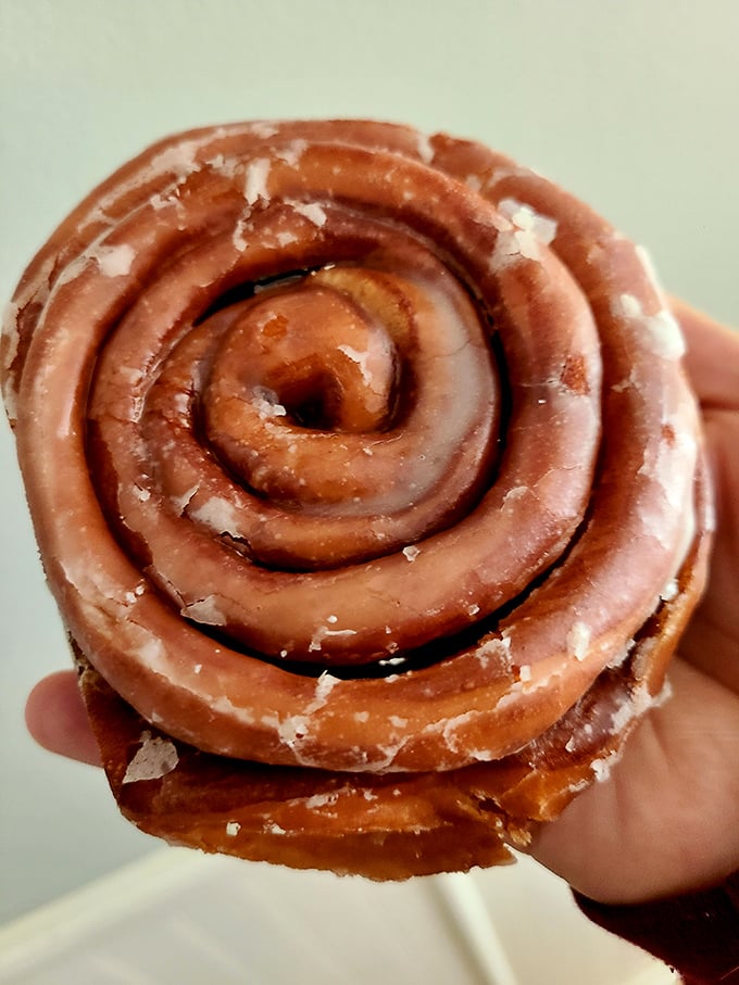 This cinnamon roll isn't just breakfast; it's an architectural marvel with layers that unfold like the plot of a good mystery novel.