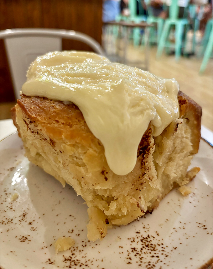 Not just any cinnamon roll—this pillowy masterpiece with its melting cream cheese frosting might make you forget every other pastry you've ever loved.