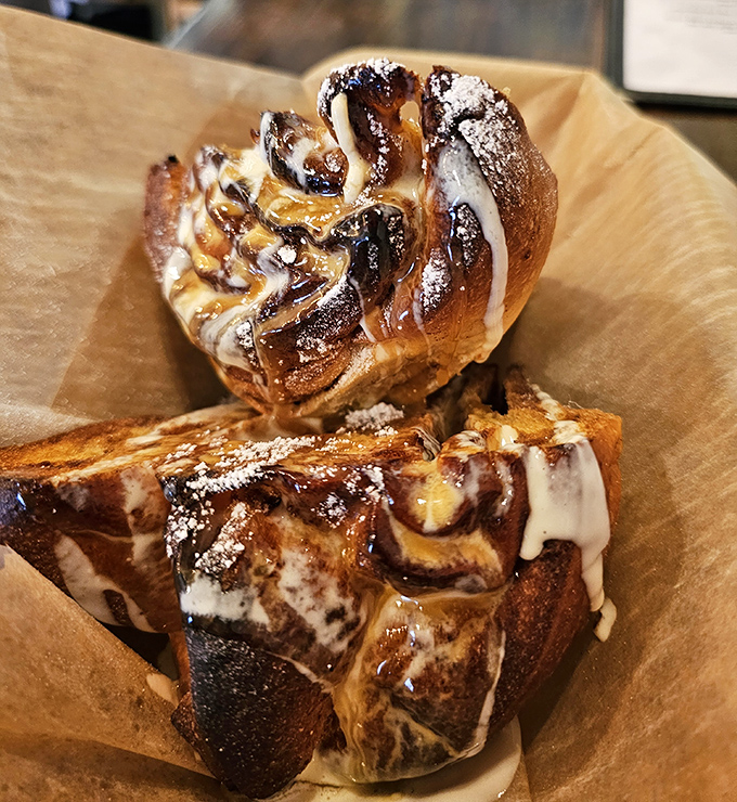 The griddled cinnamon roll glistens with bourbon brown butter caramel and maple orange icing&mdash;dessert masquerading as breakfast, and nobody's complaining.