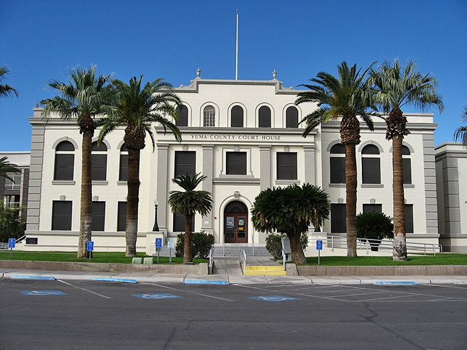 The Yuma County Courthouse, surrounded by palm trees, looks like what would happen if justice took a permanent vacation to the desert.
