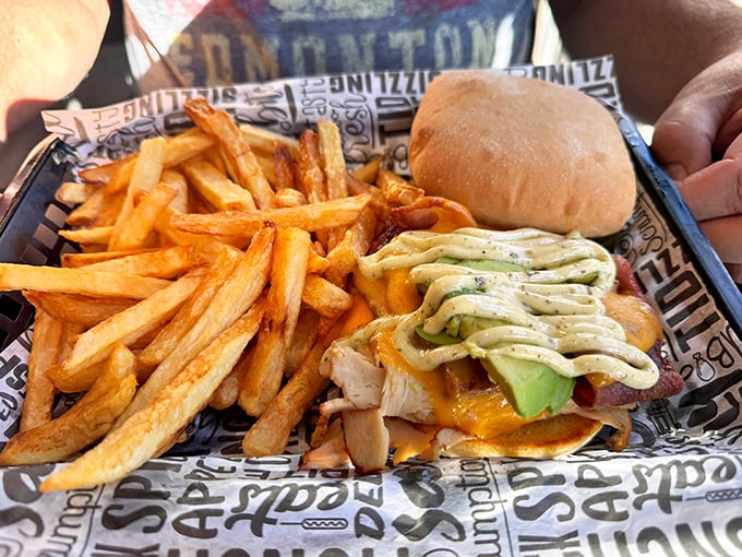 This isn't just a sandwich; it's architectural genius – golden fries alongside a masterpiece of avocado, cheese, and perfectly toasted bread.