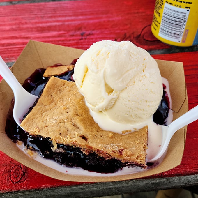 Blueberry cobbler &agrave; la mode: Where warm fruit filling meets cold vanilla ice cream in a dance as old as time, served in unpretentious paper that lets the flavors shine.