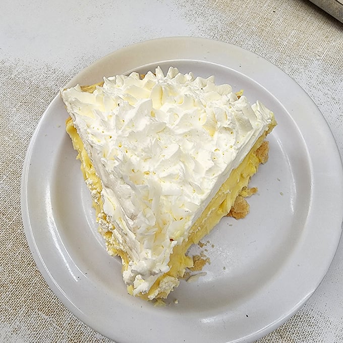 Cloud-like meringue crowns this slice of coconut cream heaven &ndash; the perfect sweet finale to a savory Coney experience.