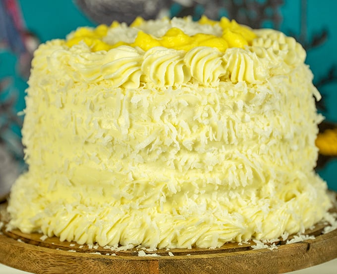 This sunshine-yellow coconut lemon cake doesn't just brighten the display case—it practically radiates happiness with each perfectly piped swirl.