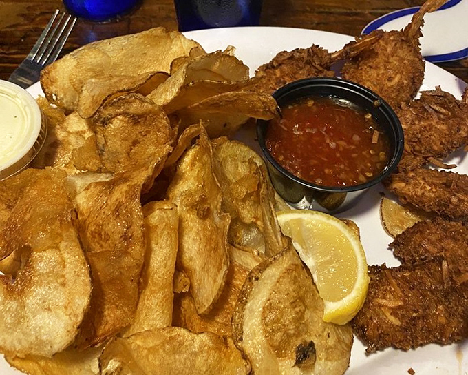 Golden-fried perfection meets the sea in this basket of coconut shrimp and Whale Fries - proof that sometimes the best things in life come in paper-lined baskets.