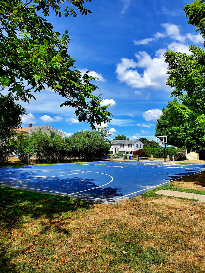 Coelho Park's vibrant blue basketball court offers neighborhood kids a splash of color against Bristol's traditional landscape.