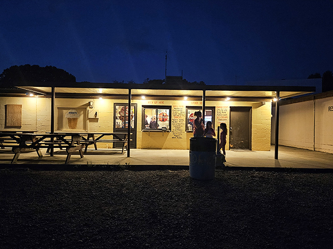The concession stand glows like a beacon in the night, promising buttery popcorn and memories that taste just as sweet.