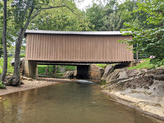 From creek level, the bridge reveals its true purpose—a practical solution to a water crossing that somehow managed to become a work of art.