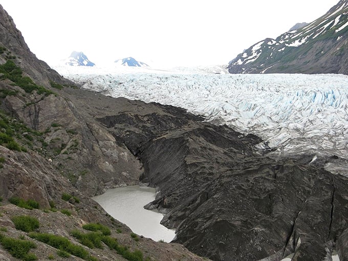 Grewingk Glacier's icy tongue licks at the landscape, carving valleys with the patience of millennia. Nature's slowest sculptor at work.