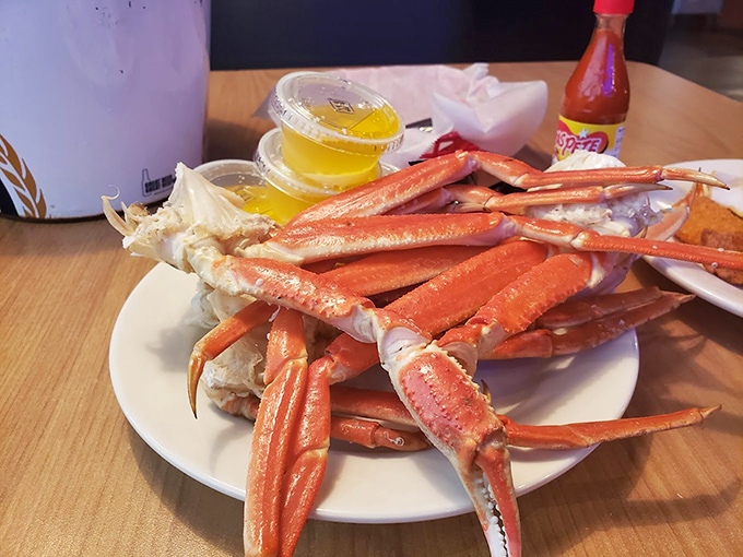 Snow crab legs arranged like nature's perfect finger food, waiting for you to crack into their sweet, tender secrets.