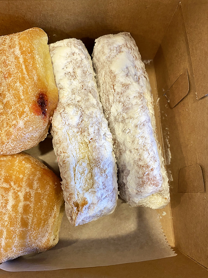 Powdered sugar donuts nestled in their cardboard cradle &ndash; the adult equivalent of finding an unexpected snow day has been declared.