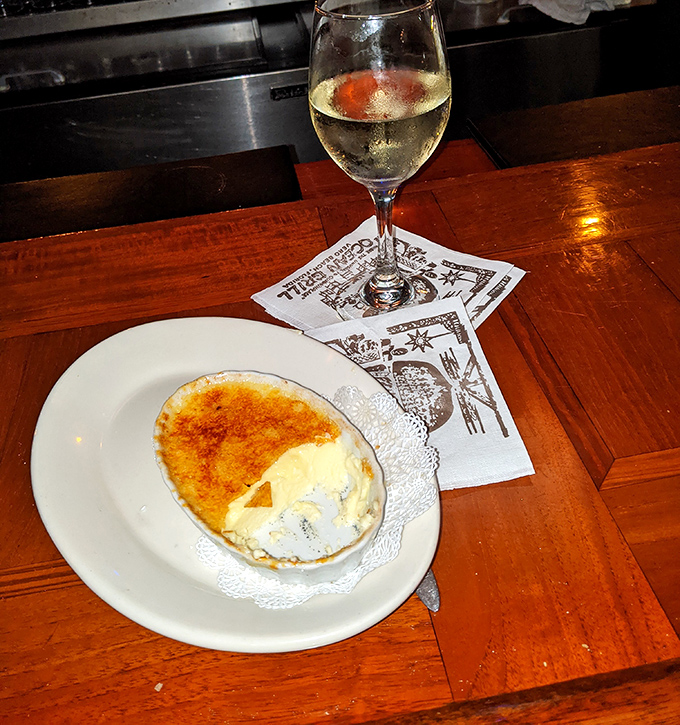 Cr&egrave;me br&ucirc;l&eacute;e with that perfect glass-like sugar crust waiting to be cracked. It's like breaking into Fort Knox, but the treasure is butterscotch bliss.