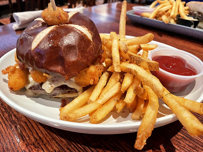 This isn't just a burger; it's architecture. A pretzel bun masterpiece with golden fries that deserve their own fan club.