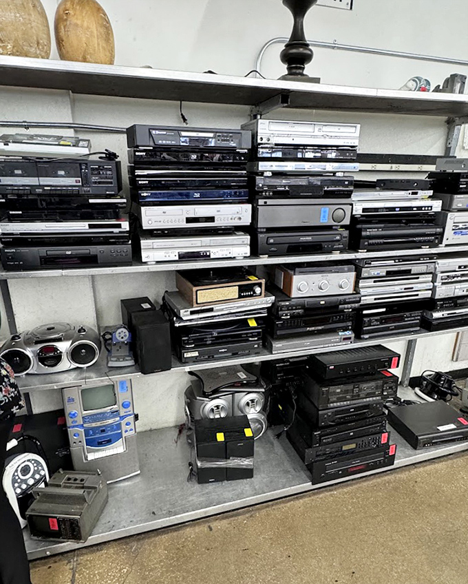 A technological time capsule stacked to the ceiling. One person's outdated electronics are another's vintage media center waiting to happen.