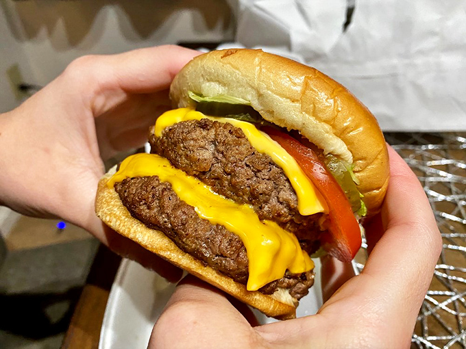 The Double Zip Burger in all its glory—where two patties and melted cheese create what philosophers might call "the perfect ratio of meat to bun."