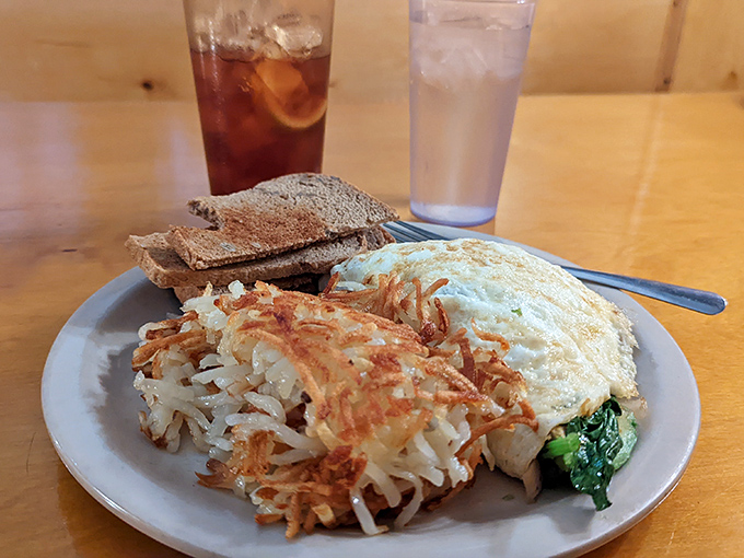 A mountain of crispy hash browns alongside a vibrant, healthy egg white omelet. This is a lighter choice, but still a heavy hitter for flavor.