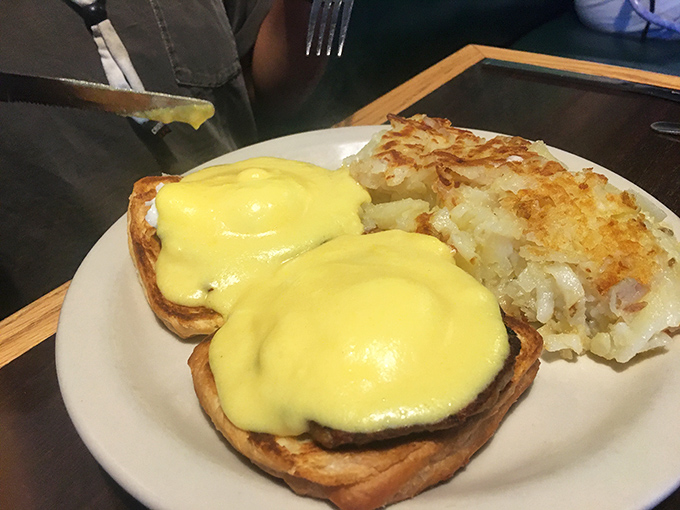 These eggs Benedict aren't just breakfast, they're a hollandaise-draped masterpiece with hash browns so crispy they deserve their own fan club.