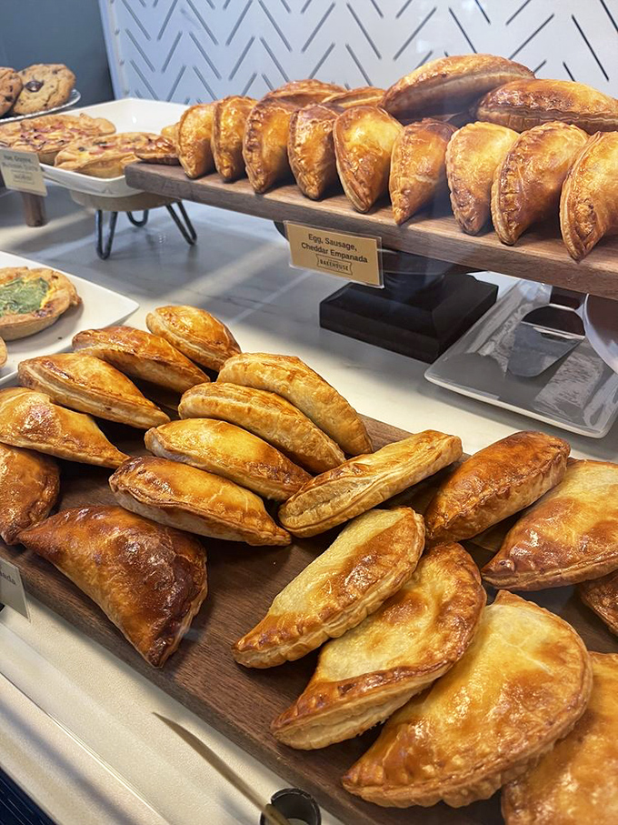 Golden empanadas lined up like delicious soldiers, their flaky armor protecting savory treasures of egg, sausage, and cheddar within.