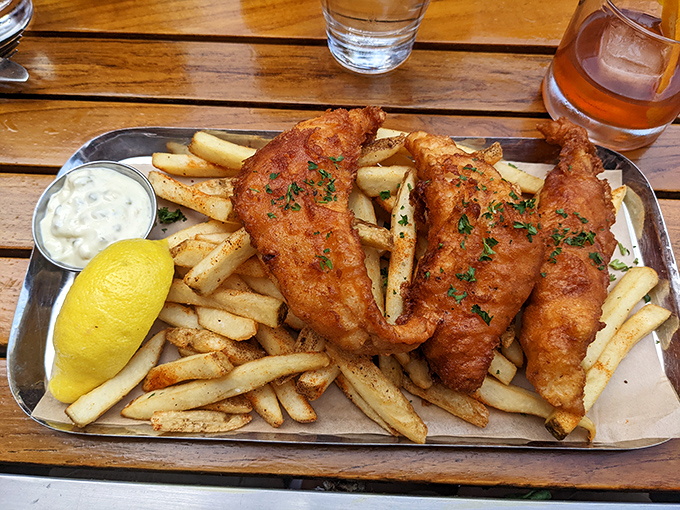 Golden-battered fish so crisp it practically sings when your fork hits it, nestled on a bed of hand-cut fries that deserve their own fan club.