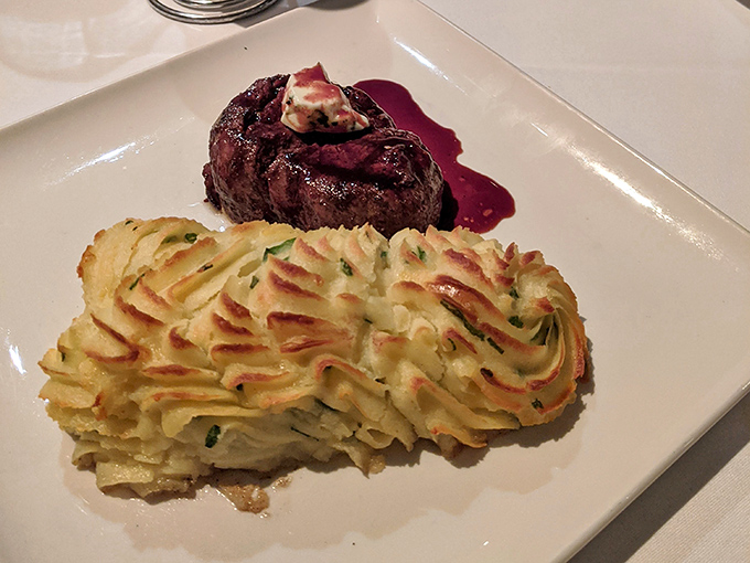 That filet gets paired with potatoes so perfectly arranged they look like edible architecture with a side of wine.