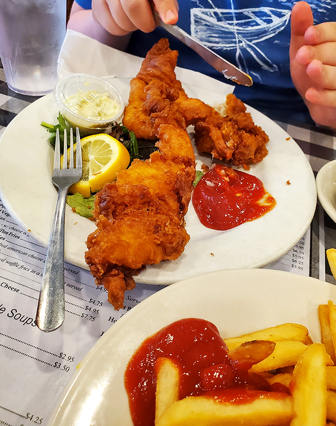Golden-battered fish that shatters with each bite, served with a splash of color and enough tartar sauce for proper dunking.