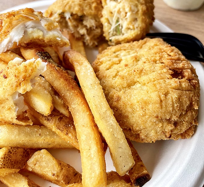 Golden-battered fish and chips with a side of clam cakes—proof that sometimes the simplest pleasures deliver the most profound satisfaction. Crispy on the outside, heaven on the inside.