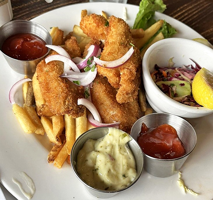 Golden-battered fish and chips with three dipping sauces&mdash;because sometimes one condiment simply cannot contain your happiness.