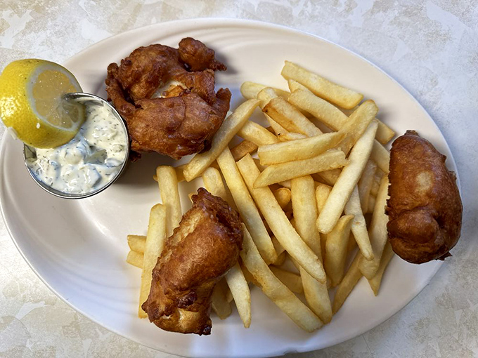 The holy trinity of Alaskan dining: golden-battered halibut, perfectly crisp fries, and house-made tartar sauce that makes you question all other condiments.