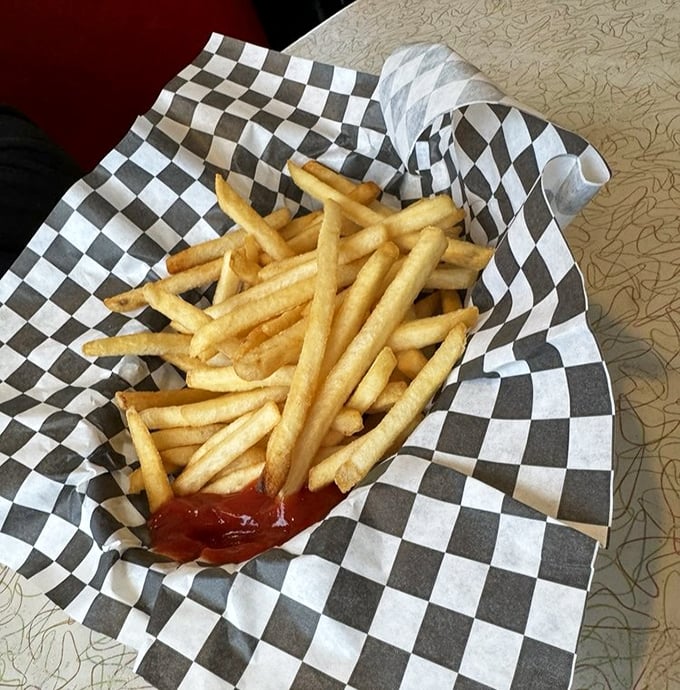 Golden fries in checkered paper &ndash; because some traditions shouldn't be messed with, ever.