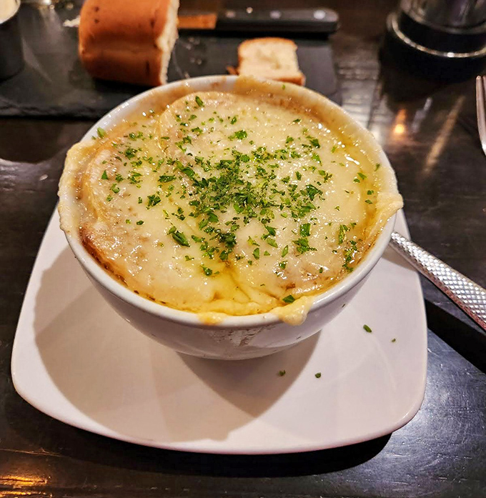 French onion soup that's achieved the golden trifecta: sweet caramelized onions, rich broth, and a cheese cap that requires commitment to break through.