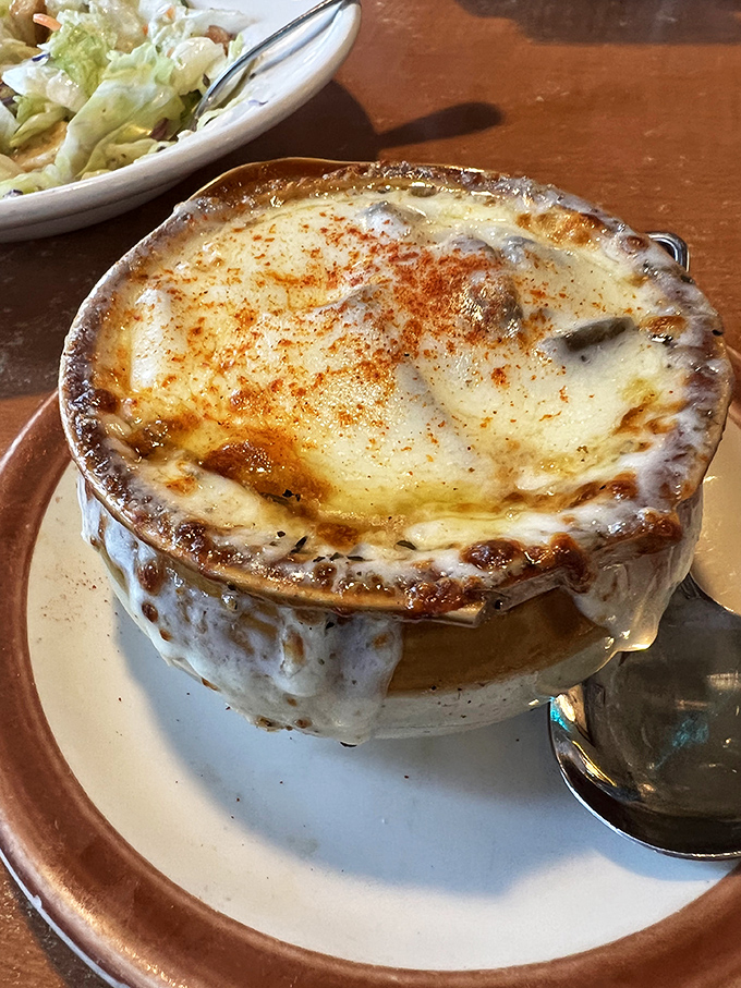 A French onion soup with a cheese pull that deserves its own slow-motion montage. The broiled crust is practically begging for a close-up