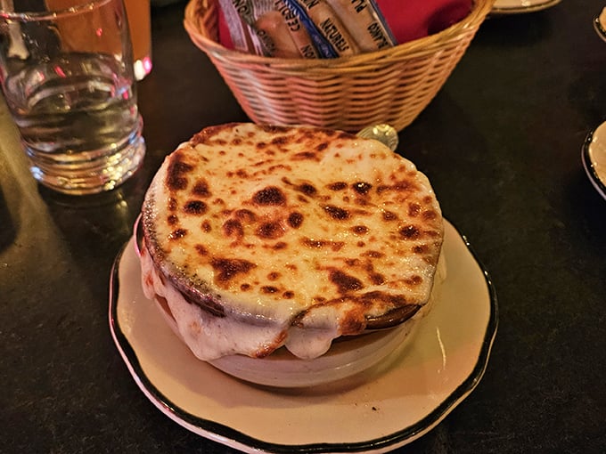French onion soup done right: a volcanic cheese eruption that requires strategy, commitment, and zero concern for your shirt's well-being.