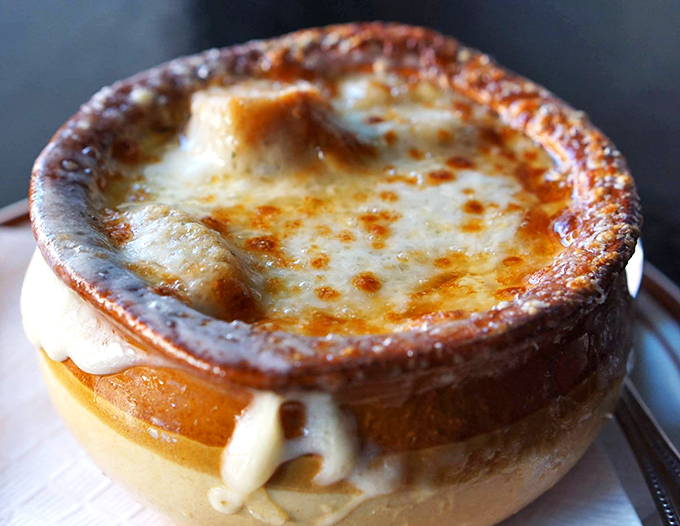 French onion soup that doesn't mess around—a bubbling cauldron of molten cheese concealing sweet onions and broth that would make a Frenchman weep with joy.