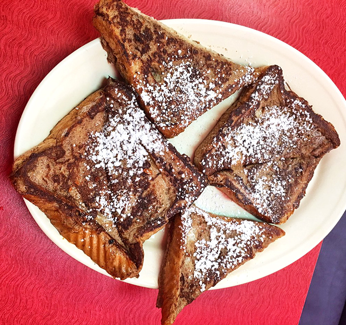 This French toast isn't just dusted with powdered sugar—it's wearing a delicate snowfall of sweetness that transforms bread into morning magic.