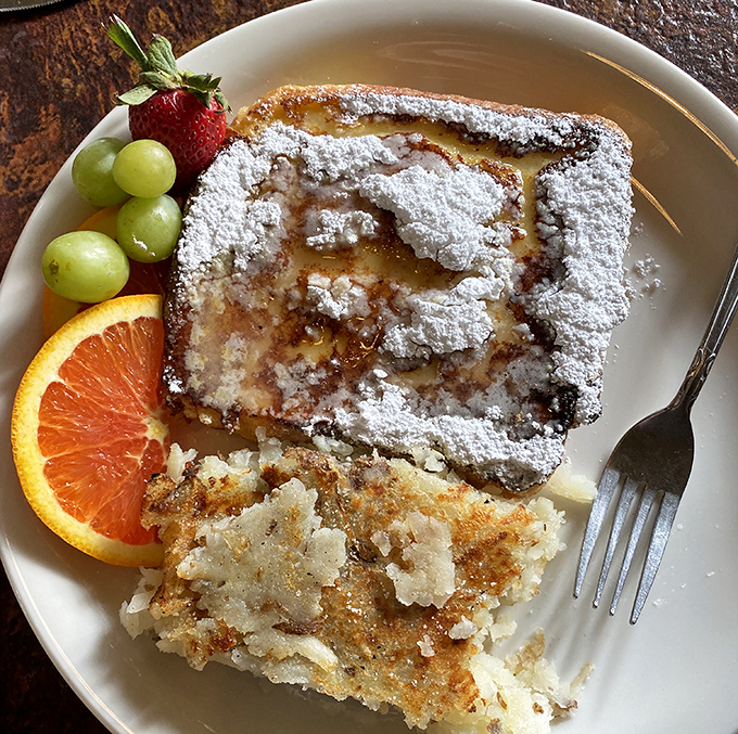 French Toast dusted with powdered sugar snow, served with hashbrowns that could make a potato farmer weep with pride.