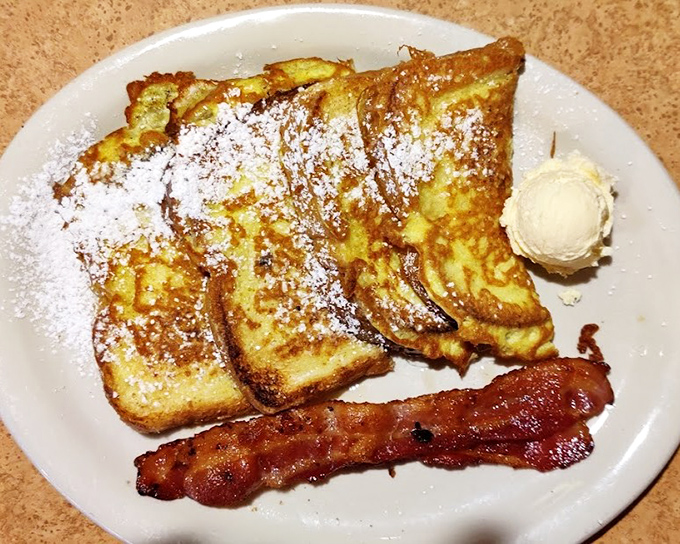 French toast that looks like it graduated from culinary school with honors &ndash; dusted with powdered sugar like morning snow.
