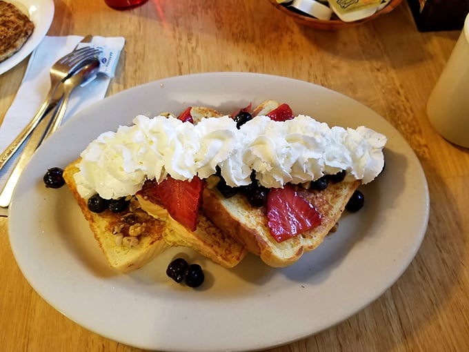 French toast crowned with berries and whipped cream &ndash; dessert masquerading as breakfast, and nobody's complaining about the deception.