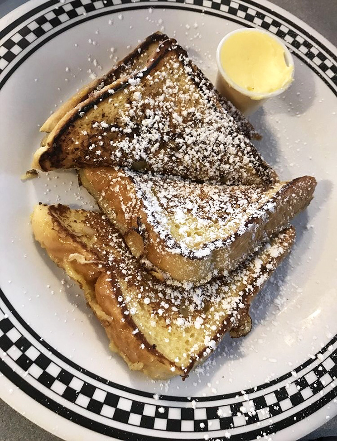 French toast dusted with powdered sugar and served with a side of butter &ndash; simple pleasures that make mornings worth facing.