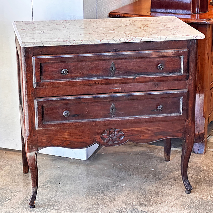 This marble-topped commode has more character in its wooden legs than most modern furniture has in its entire existence. 