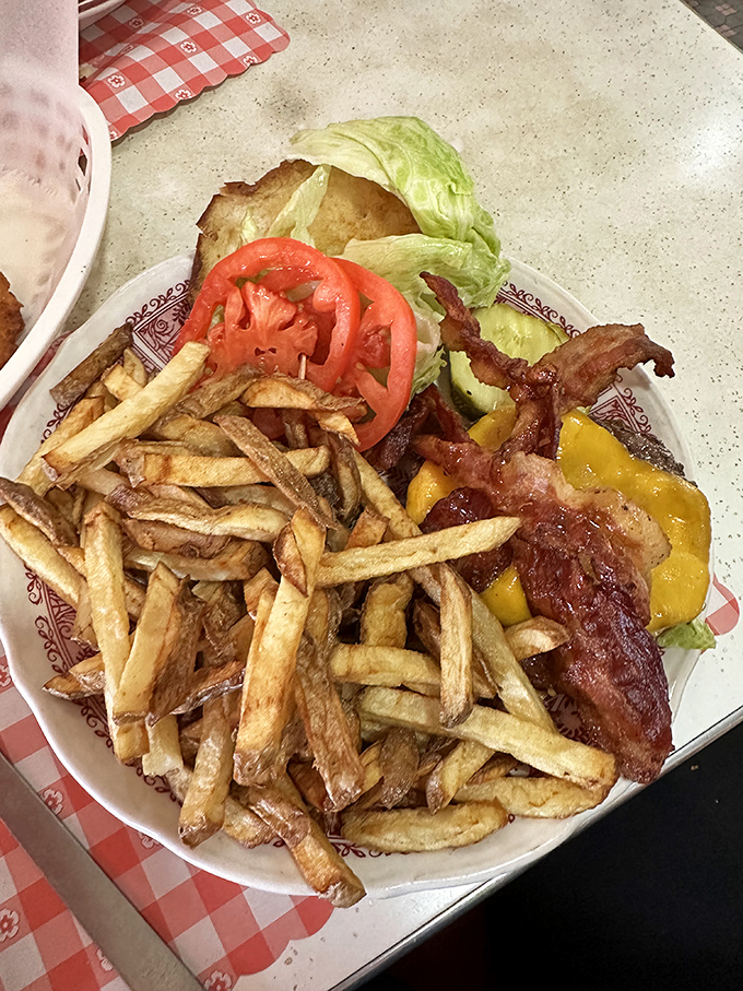 The burger arrives like a work of art&mdash;crispy hand-cut fries, fresh toppings, and enough bacon to make even Ron Swanson smile with approval.