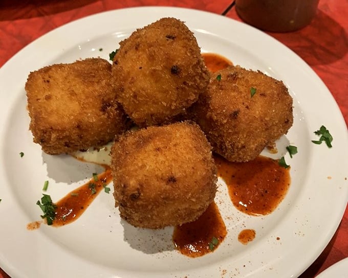 Fried mac and cheese bites that would make your cardiologist wince and your taste buds sing. Crispy outside, molten cheesy goodness inside.