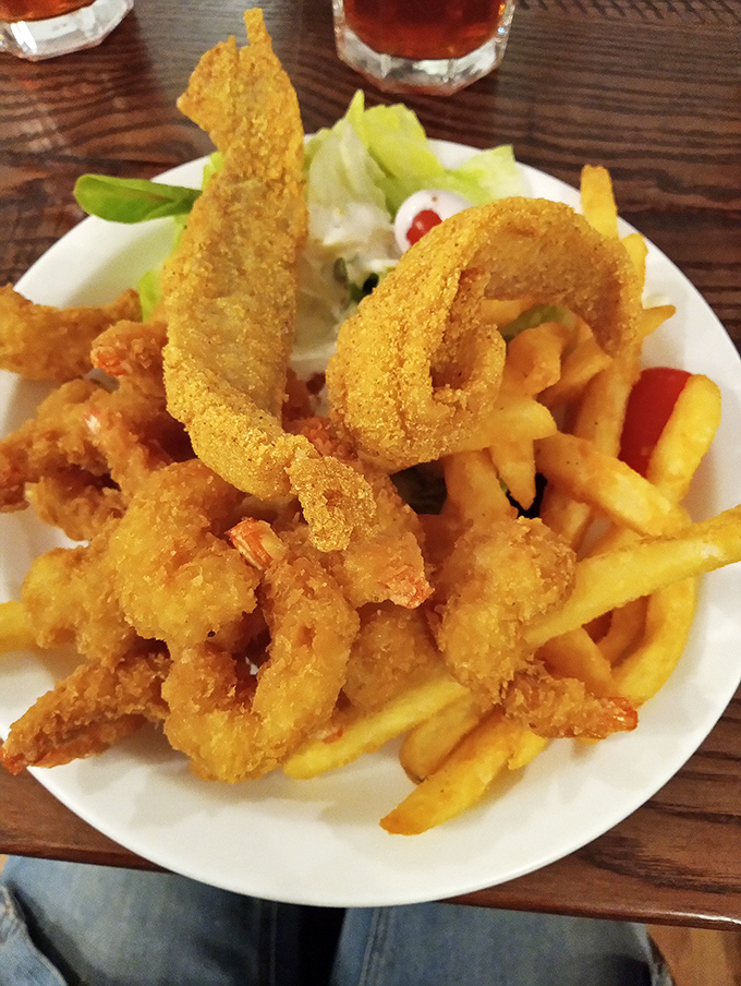 Golden-fried shrimp and crispy fries&mdash;comfort food that transcends geography. The ocean may be far, but seafood perfection is right here.