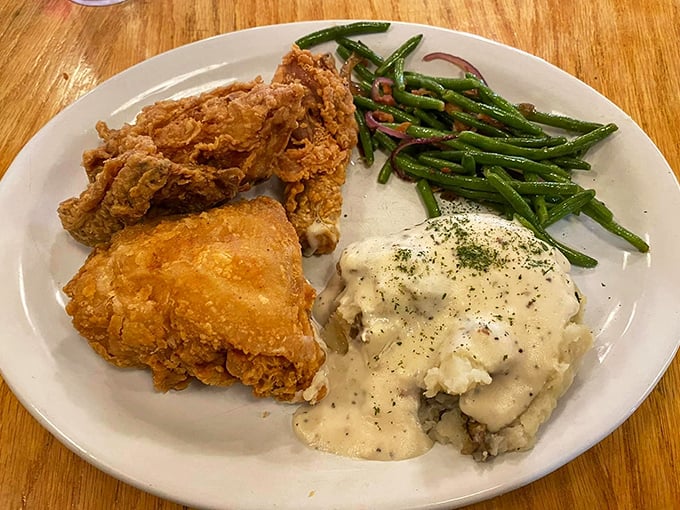 Fried chicken that would make your grandmother both proud and jealous, served alongside mashed potatoes drowning happily in gravy and green beans for "balance."