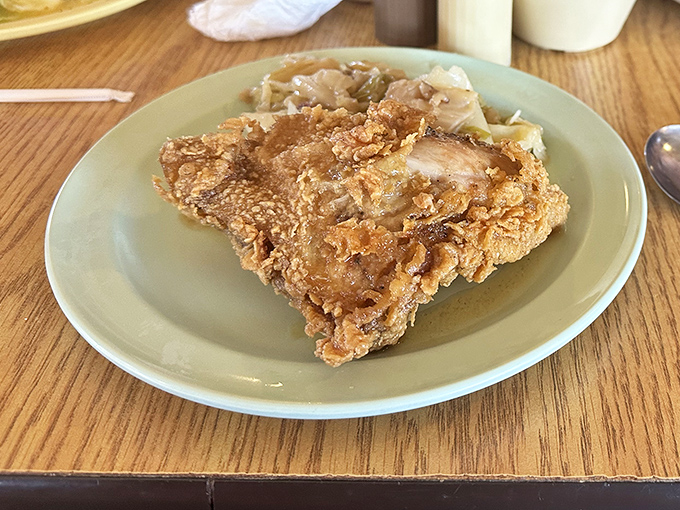 Fried chicken with a crust that shatters like autumn leaves, revealing juicy secrets beneath its crispy armor.