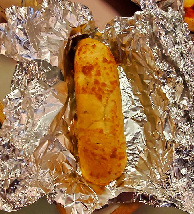 Garlic bread that's achieved the golden ratio of crunch-to-chew. The cheese spots have caramelized into what can only be described as flavor freckles.