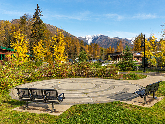 Fall's golden touch transforms Girdwood's town square into a meditation garden where benches invite contemplation beneath snow-dusted peaks.
