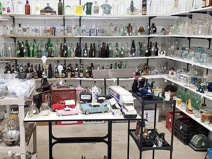 Bottle collectors, brace yourselves! This glass menagerie features everything from soda memorabilia to antique decanters, with miniature cars parked front and center.