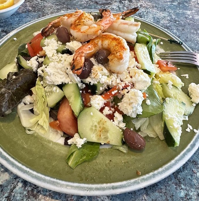 Who knew healthy could look this good? Plump shrimp perch atop a Greek salad that's a Mediterranean vacation on a plate.