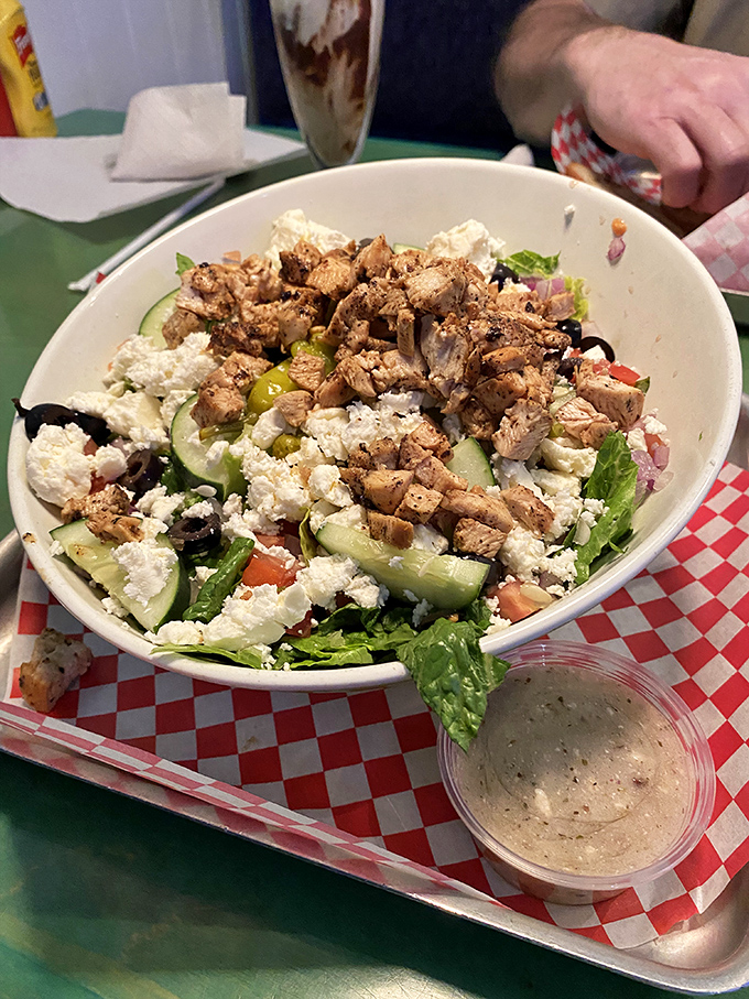 Beyond burgers, Big Billy's fresh Greek salad with grilled chicken and feta proves their menu versatility isn't just talk.
